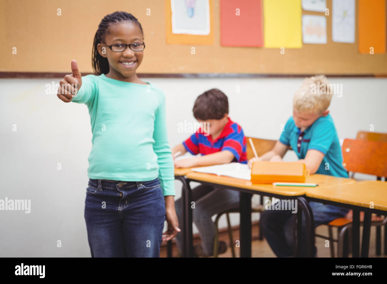 Smiling student with thumbs up Stock Photo - Alamy