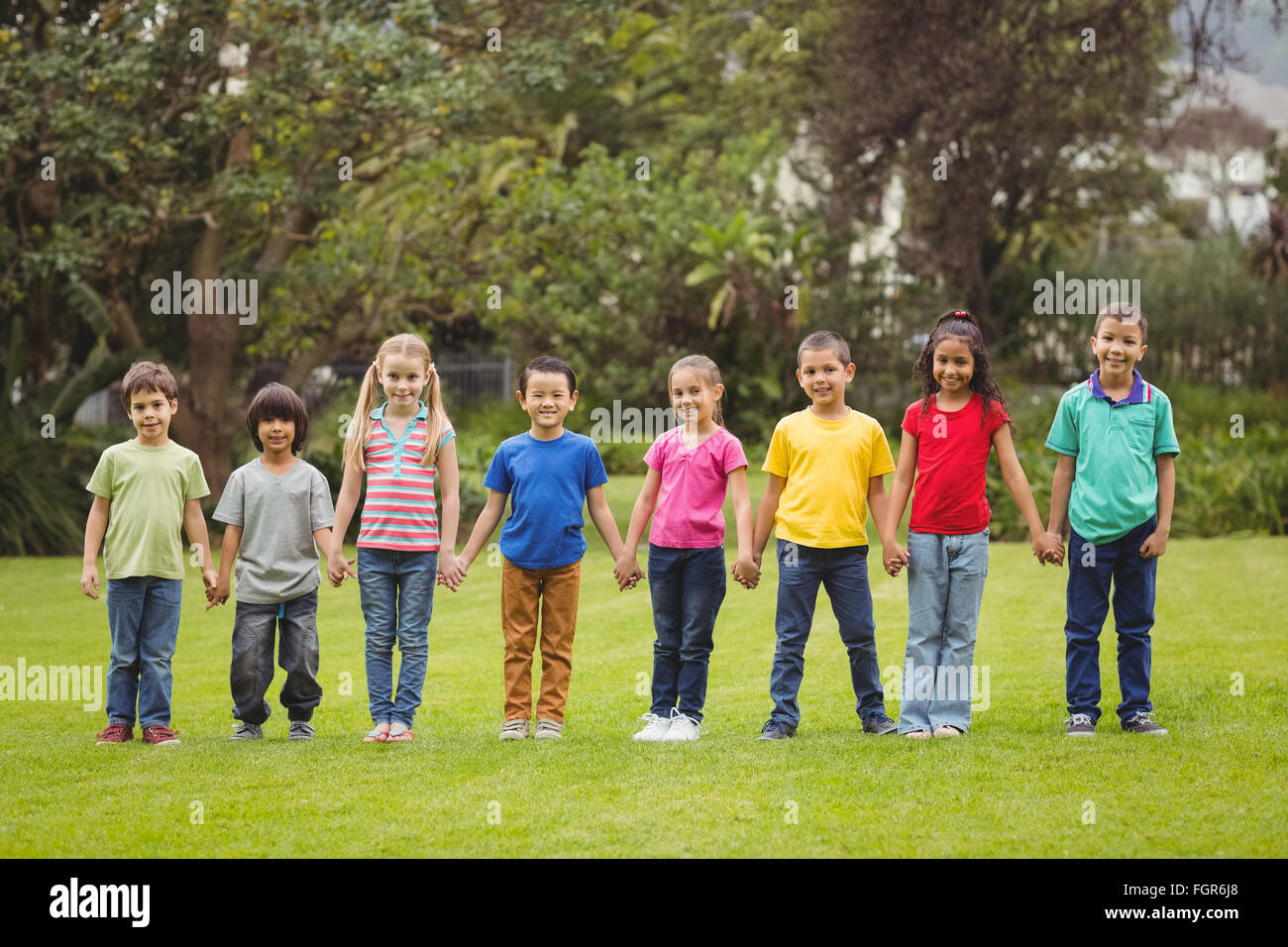 Cute pupils posing on the grass outside Stock Photo - Alamy
