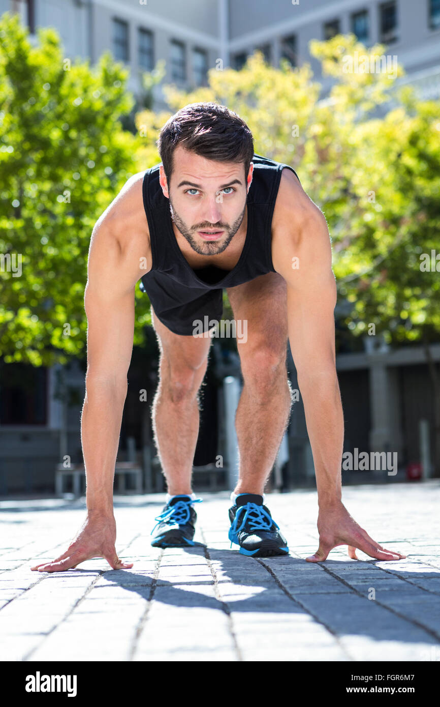 Handsome athlete in running stance Stock Photo - Alamy