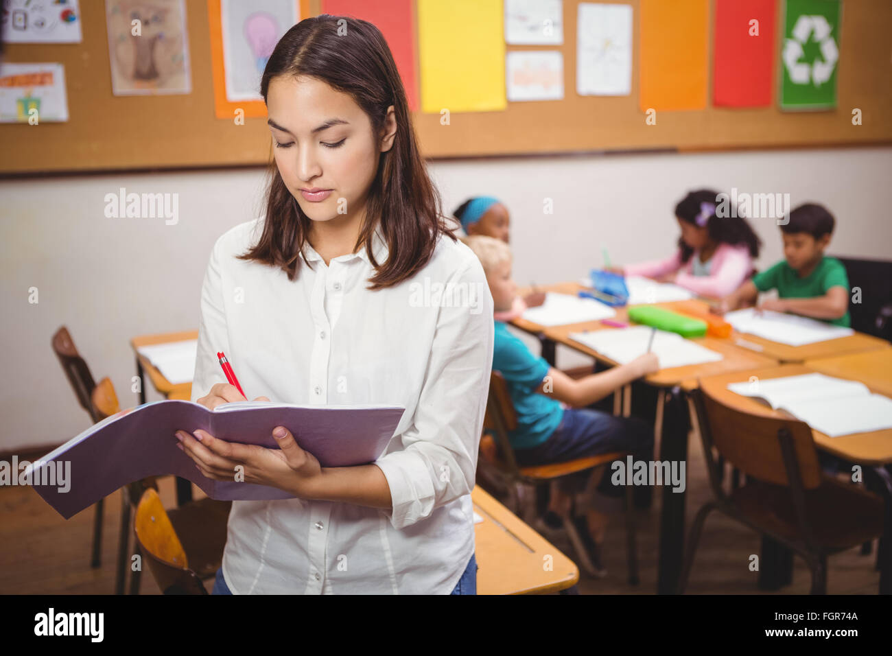 Teacher correcting some class work Stock Photo - Alamy