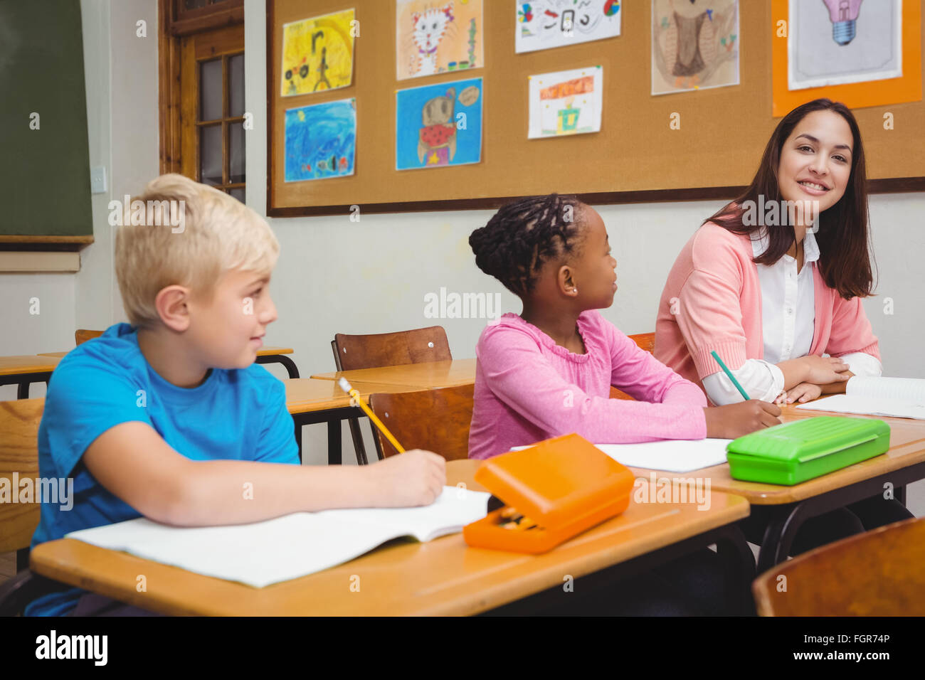 Teacher sitting with her students Stock Photo - Alamy
