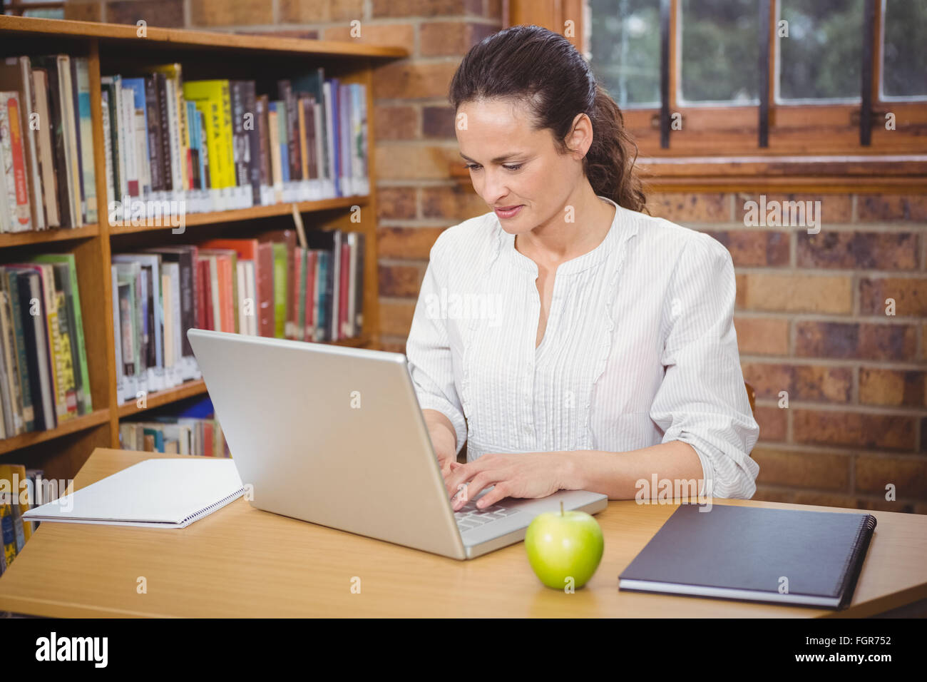 Teacher using her laptop for work Stock Photo - Alamy
