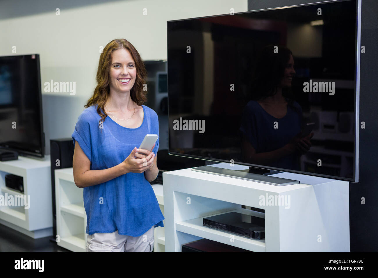 Pretty woman shopping for new television Stock Photo - Alamy
