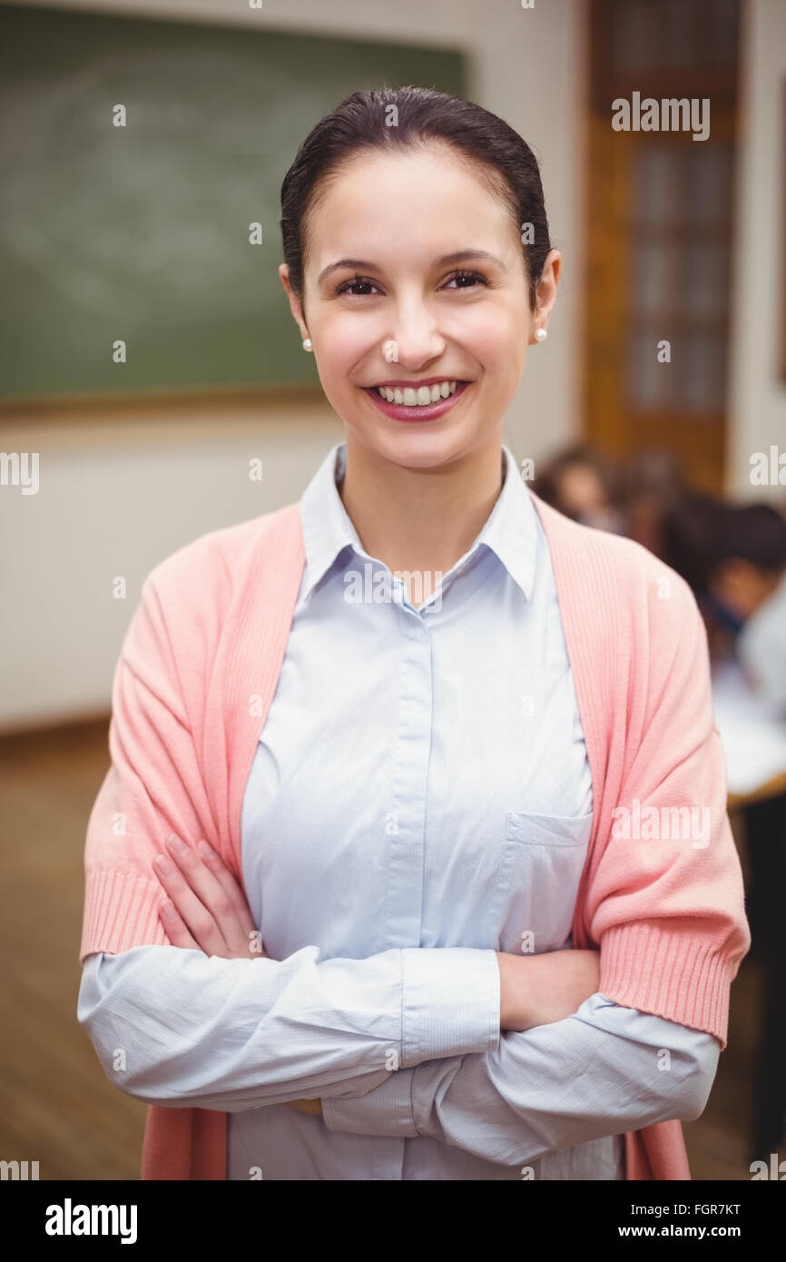 Teacher smiling at camera in classroom Stock Photo - Alamy
