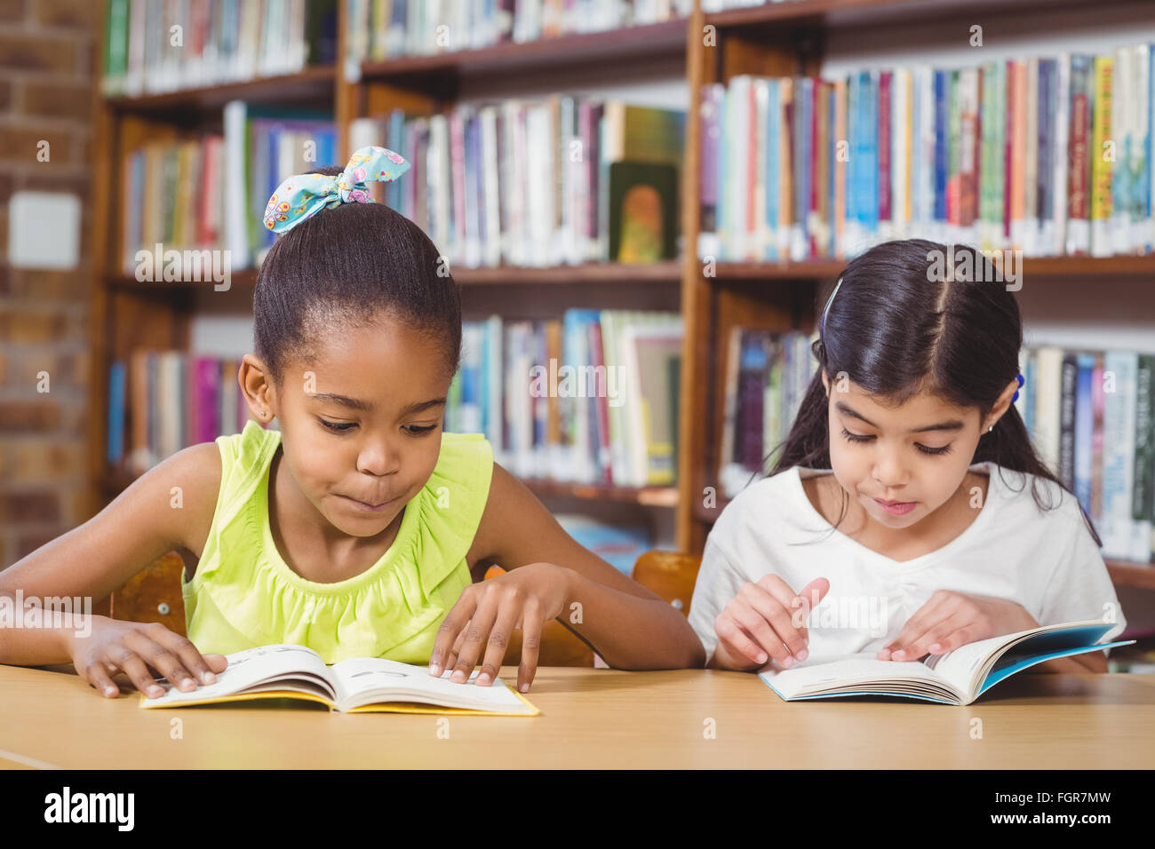 Pupils reading books in the library Stock Photo - Alamy