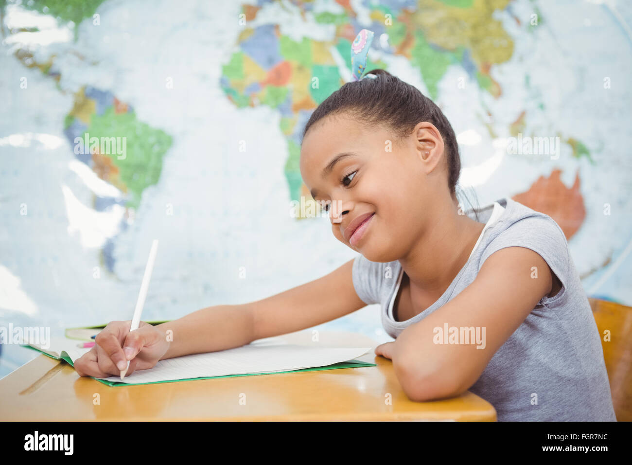 Smiling student doing class work Stock Photo - Alamy