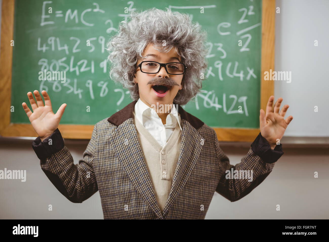 Little Einstein smiling in front of chalkboard Stock Photo - Alamy