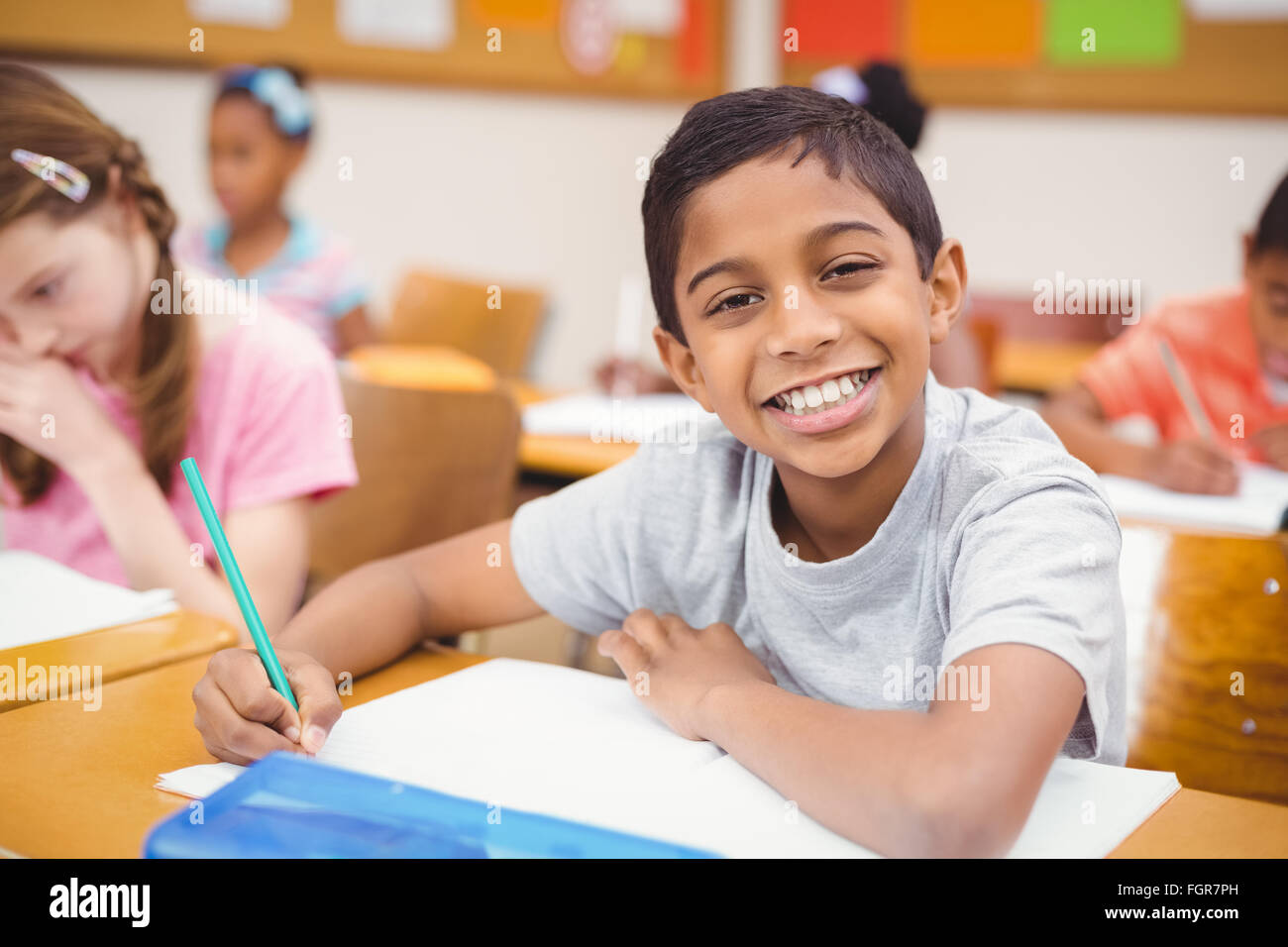 Pupil working at his desk Stock Photo - Alamy