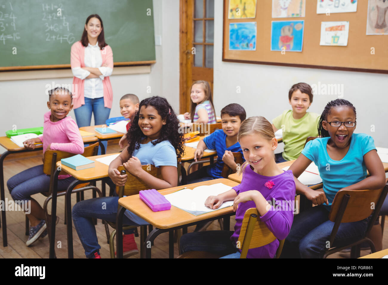 Students and teacher looking at the camera Stock Photo - Alamy