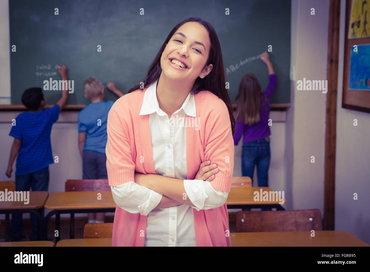 Teacher standing with students at blackboard Stock Photo - Alamy