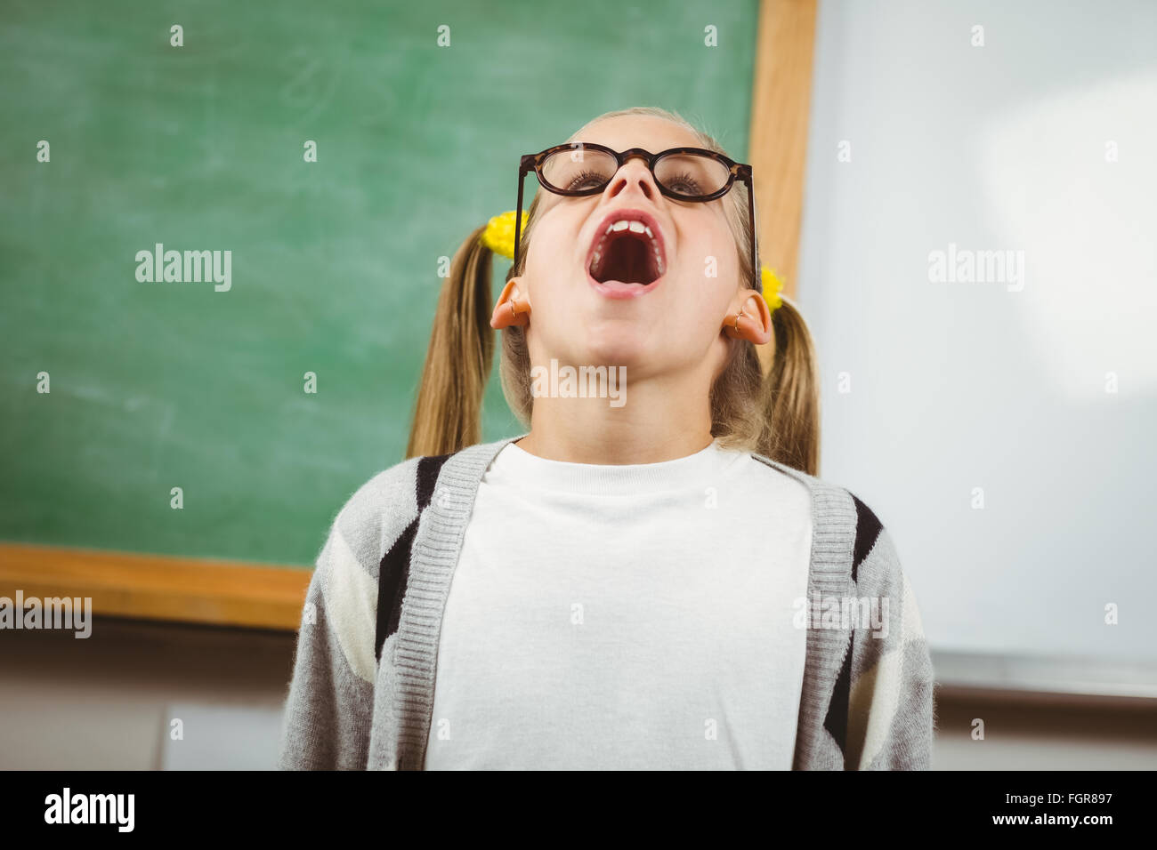 Cute pupil yelling in a classroom Stock Photo - Alamy