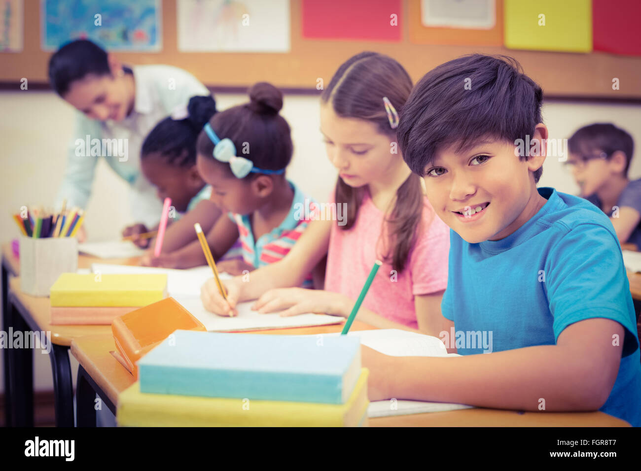 Pupils working at their desks in class Stock Photo - Alamy