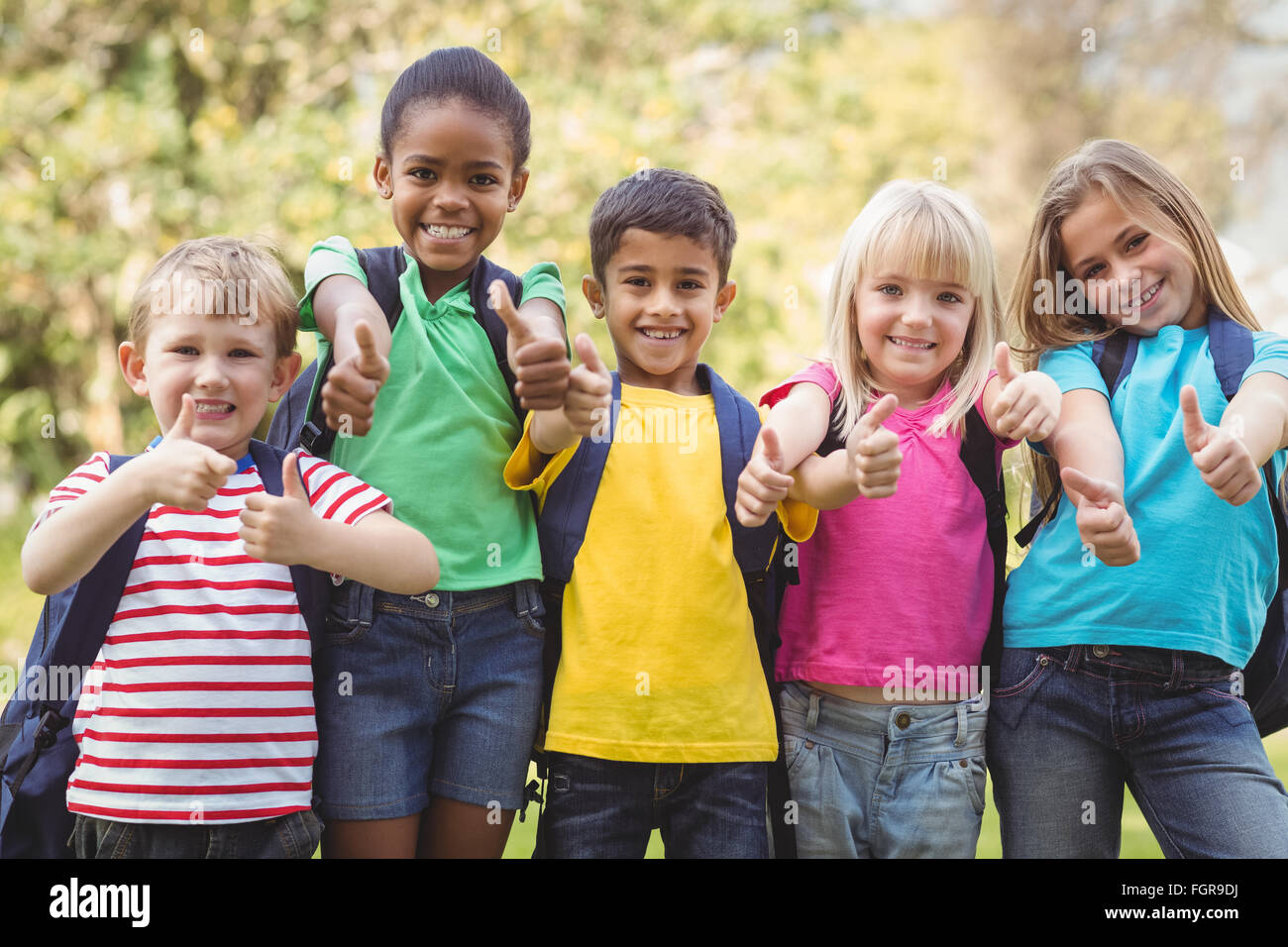Smiling classmates doing thumbs up to camera Stock Photo - Alamy
