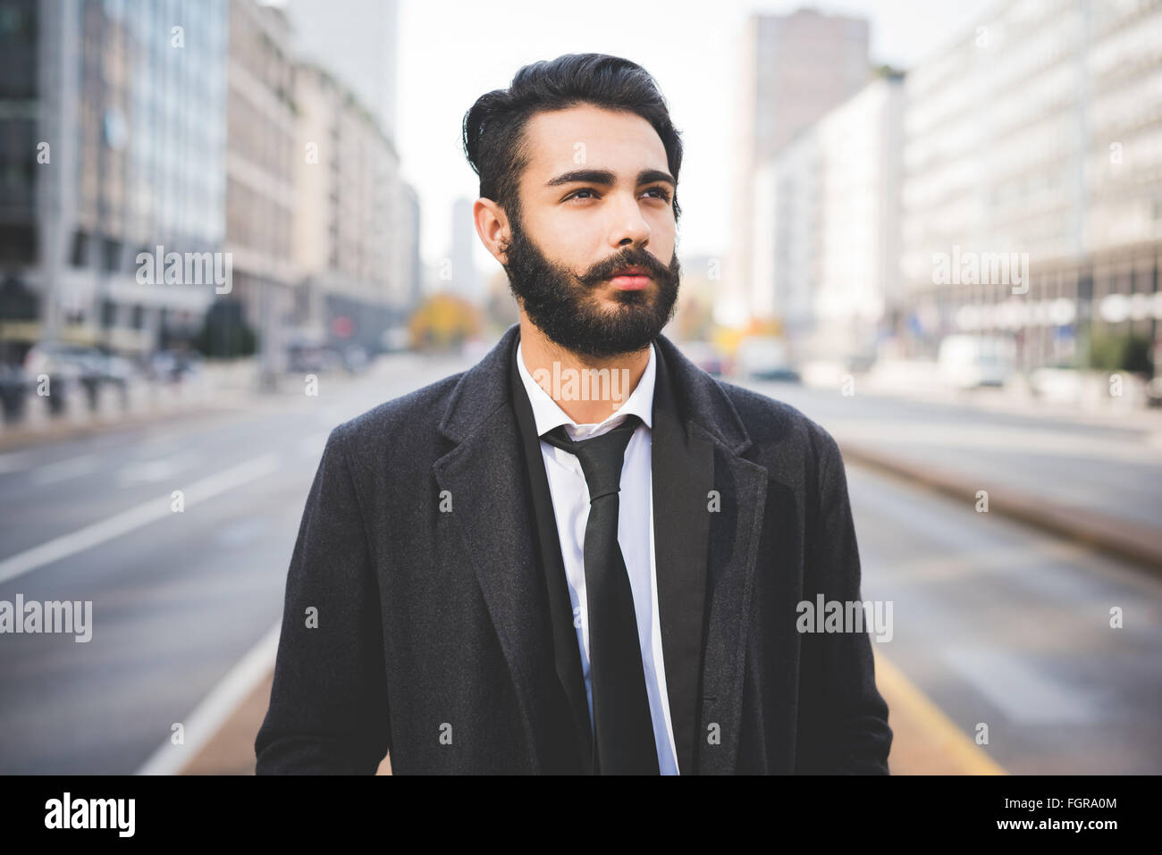 Half length of young handsome caucasian bearded businessman posing ...