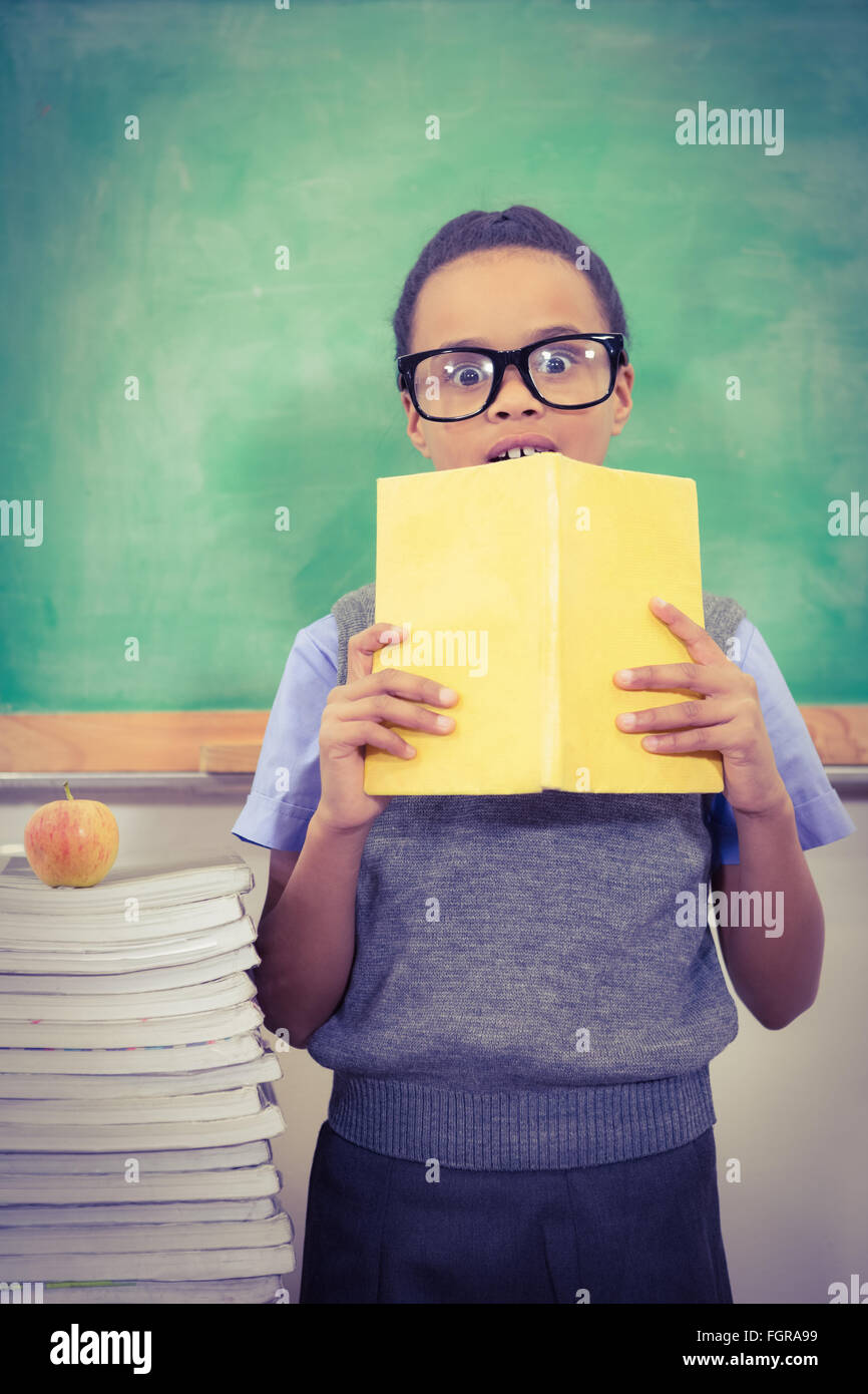 Shocked student holding a book Stock Photo - Alamy