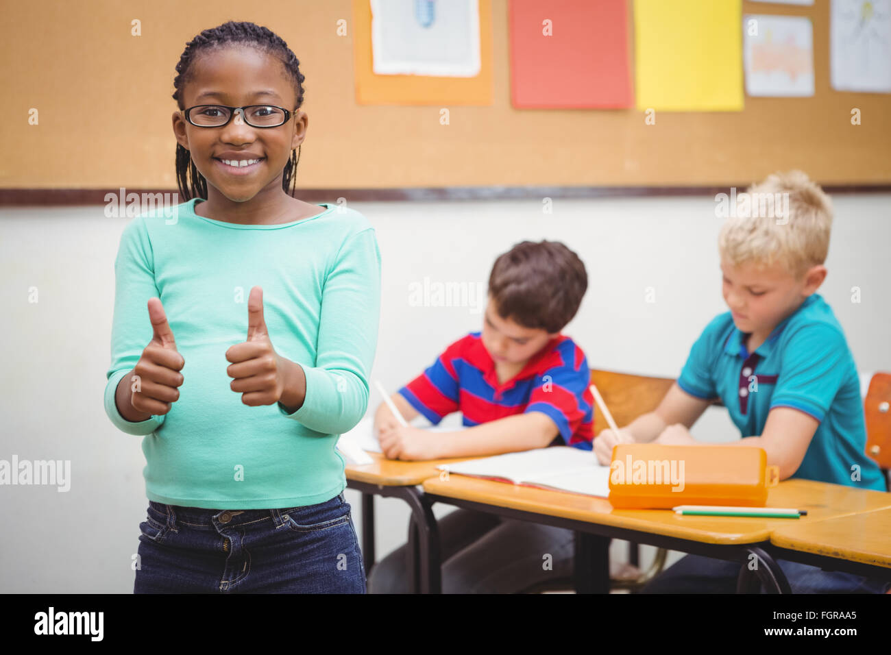 Smiling student with thumbs up Stock Photo - Alamy