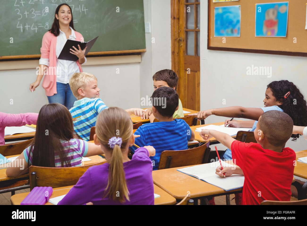 Students pointing at fellow classmate Stock Photo - Alamy