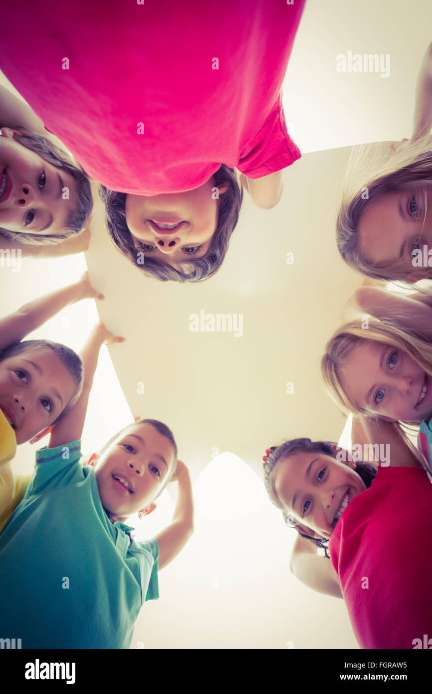 Cute pupils showing large poster Stock Photo - Alamy