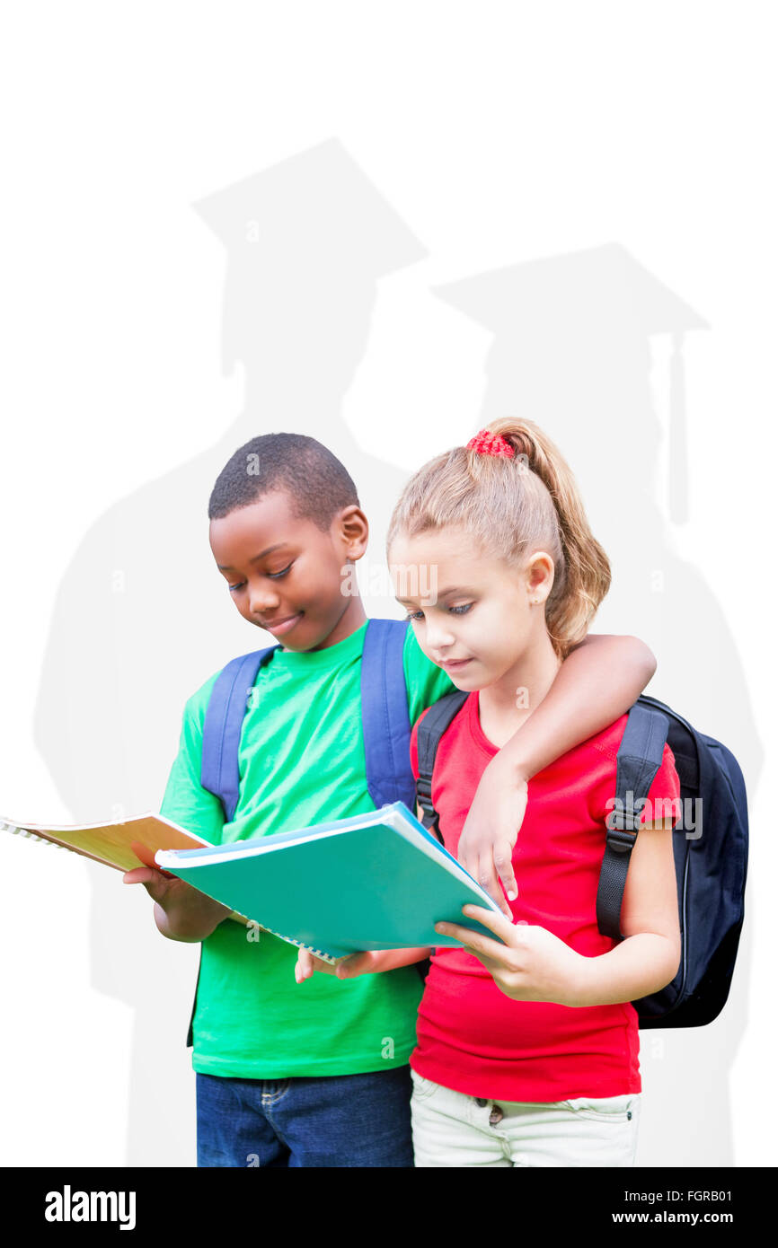 Composite image of cute pupils reading Stock Photo - Alamy