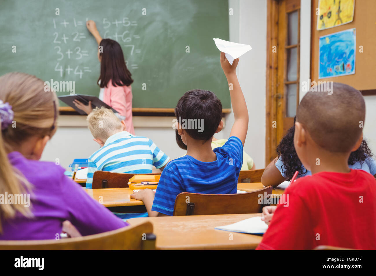 Student about to throw a paper airplane Stock Photo - Alamy