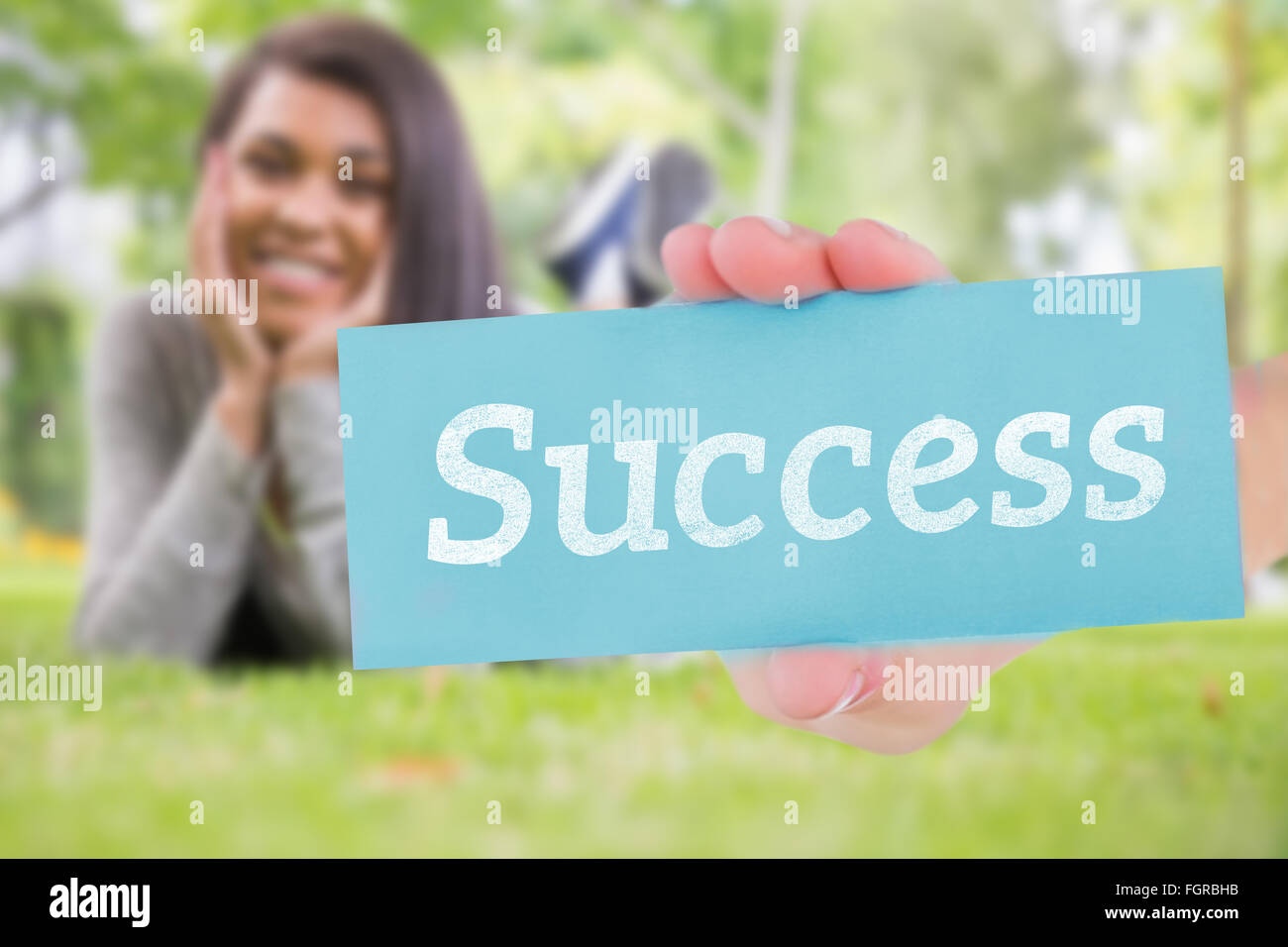 Success against pretty brunette smiling at camera in park Stock Photo ...