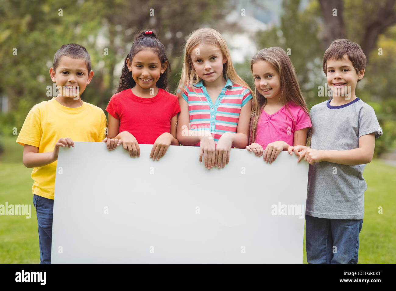 Cute pupils showing large poster Stock Photo - Alamy