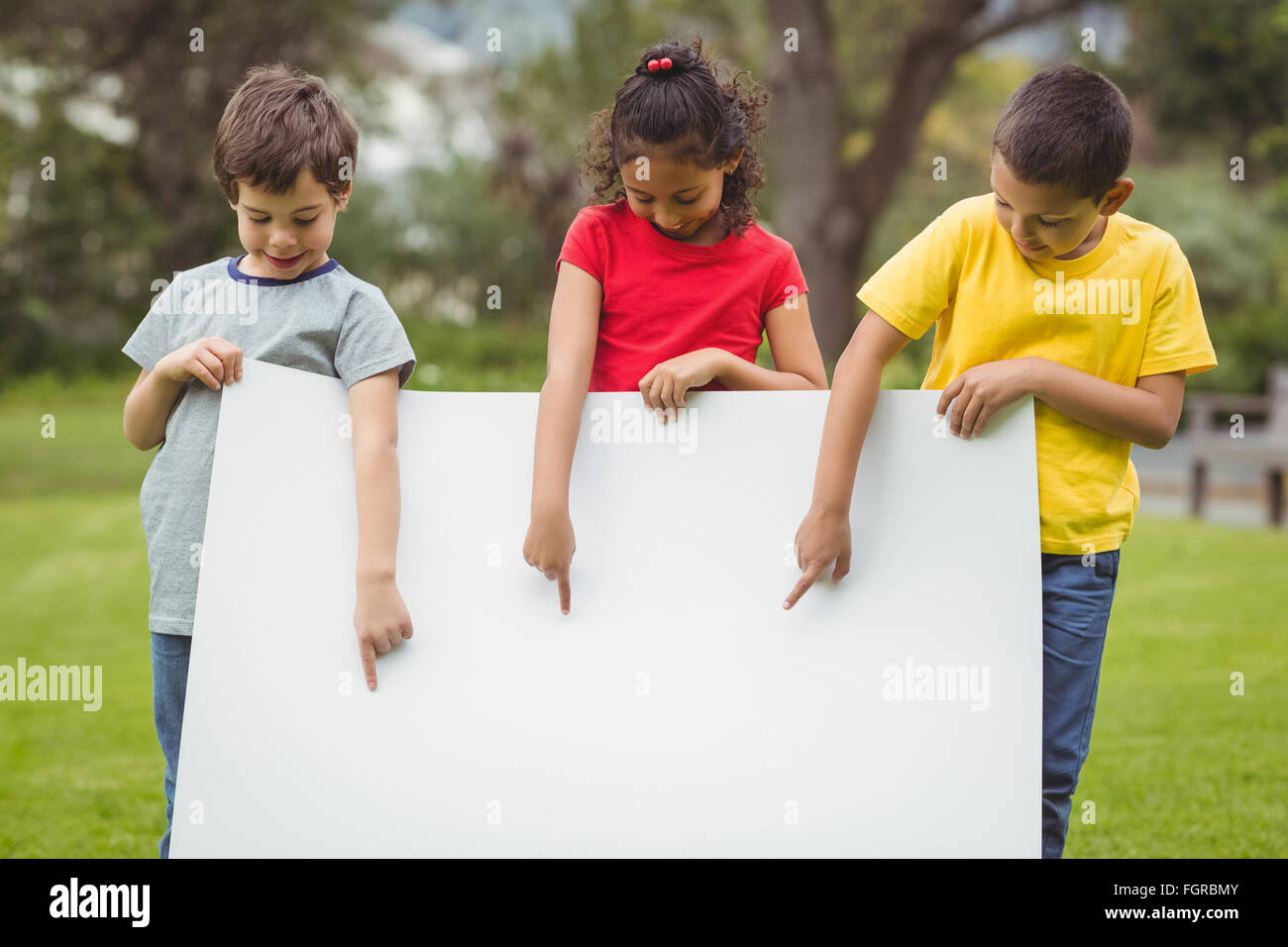 Cute pupils showing large poster Stock Photo - Alamy