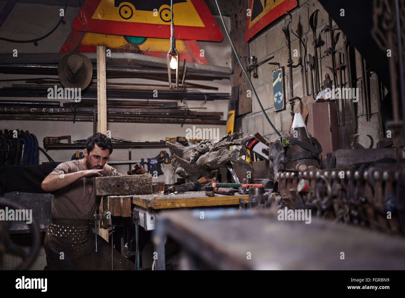 Blacksmith working in forge Stock Photo - Alamy