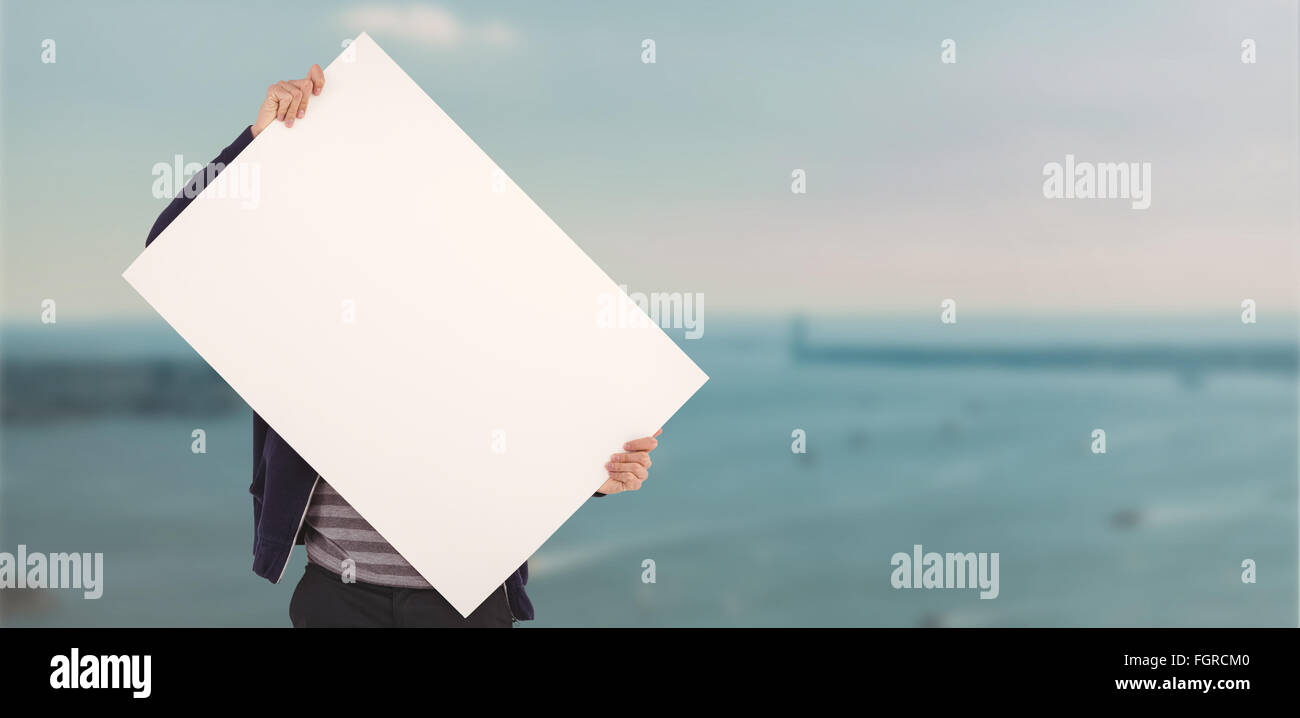 Composite image of man holding billboard in front of face Stock Photo ...