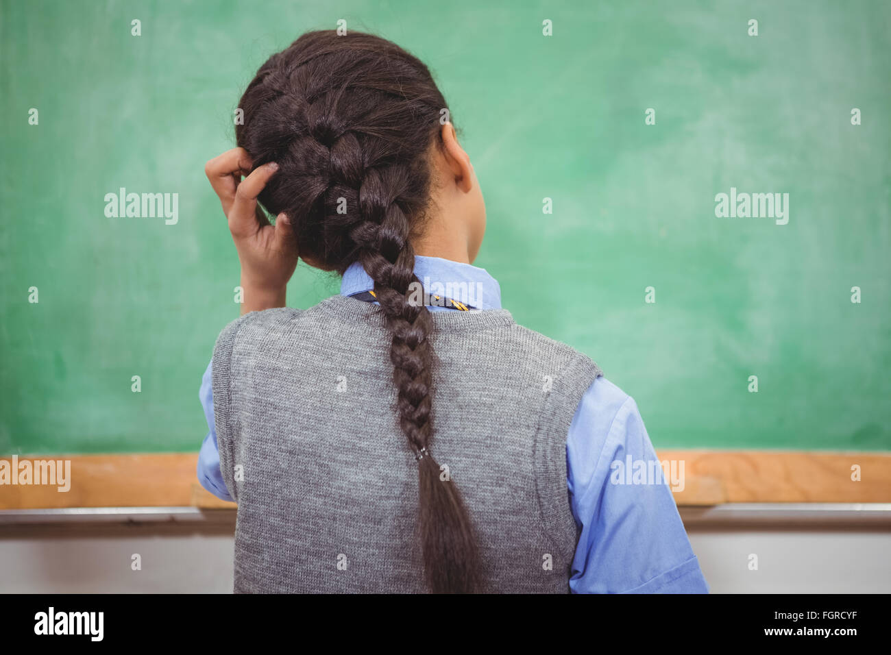 Puzzled student scratching their head Stock Photo - Alamy