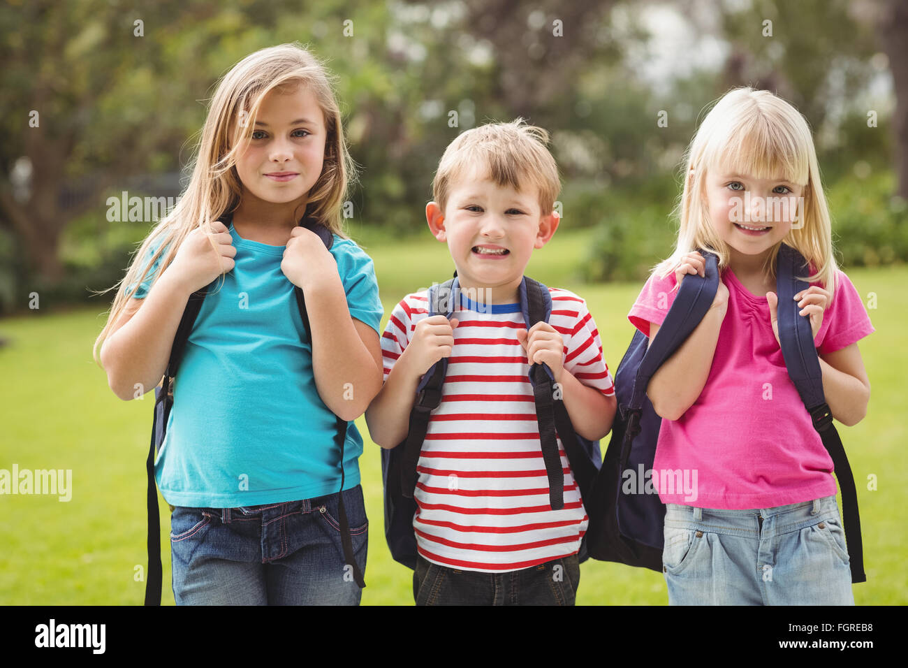 Smiling classmates with schoolbags Stock Photo - Alamy