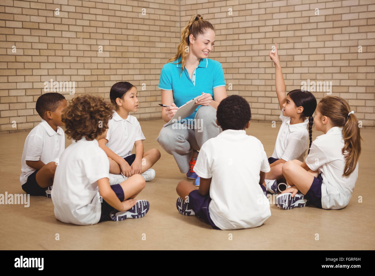 Students sitting and listening to the teacher Stock Photo - Alamy