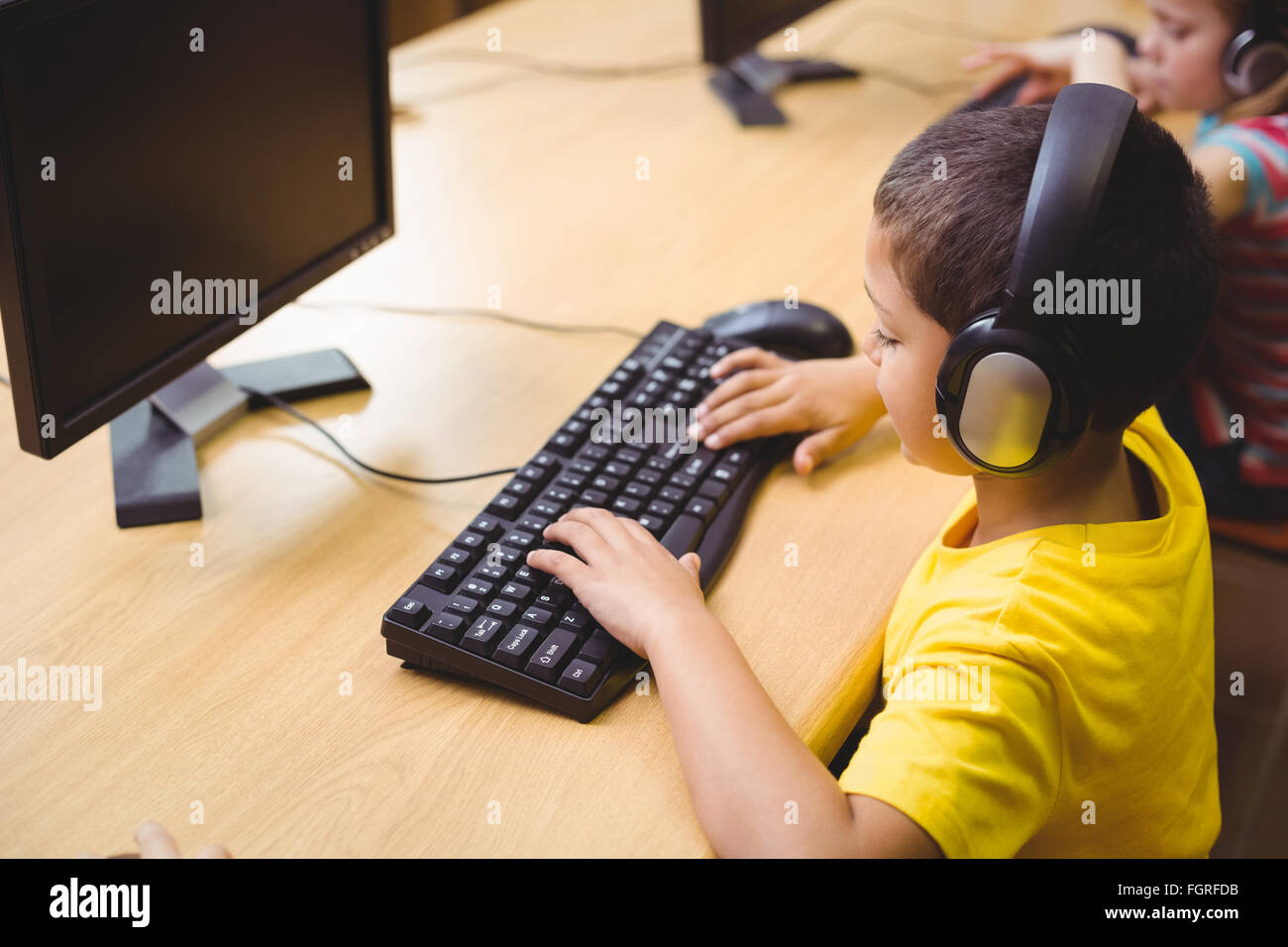 Cute pupil in computer class Stock Photo - Alamy
