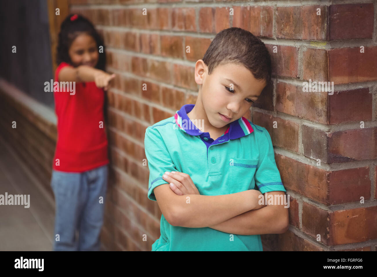 Upset child being teased by another child Stock Photo - Alamy