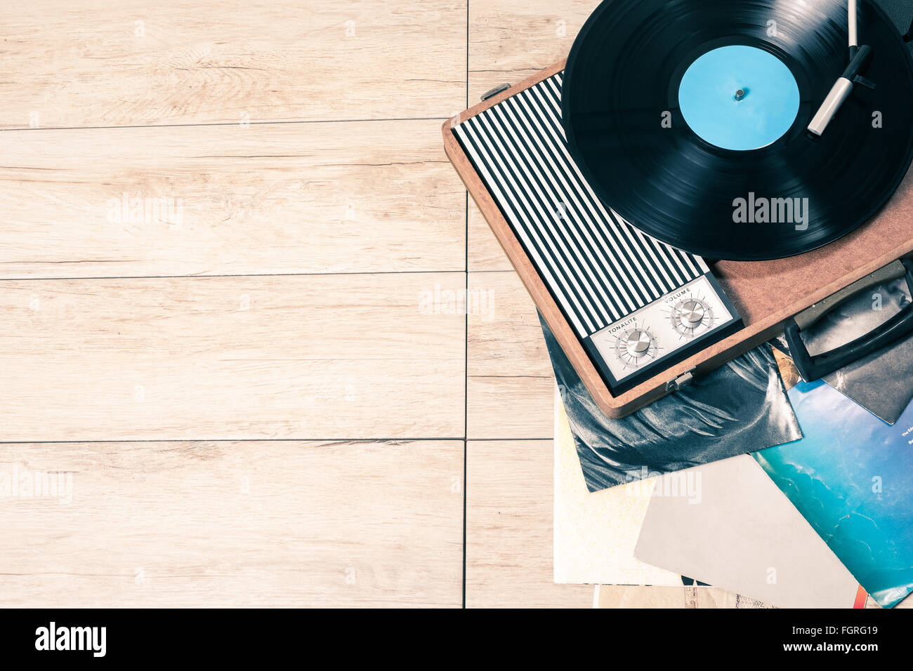 Gramophone with a vinyl record on wooden table, top view and copy space ...