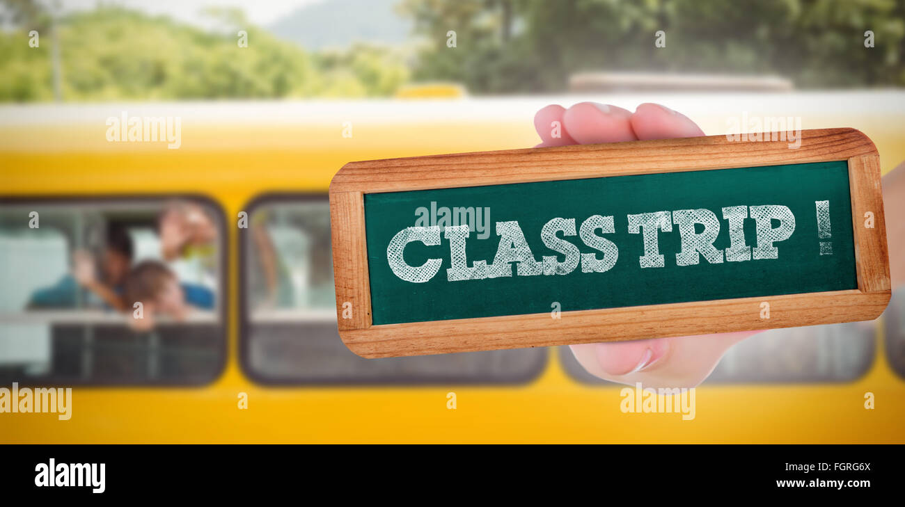Class trip! against cute pupils smiling at camera in the school bus ...