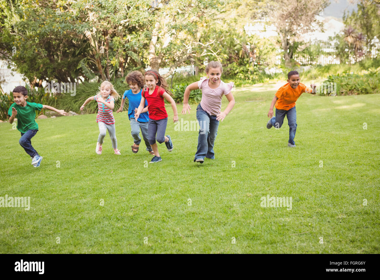 Children running on the grass Stock Photo - Alamy
