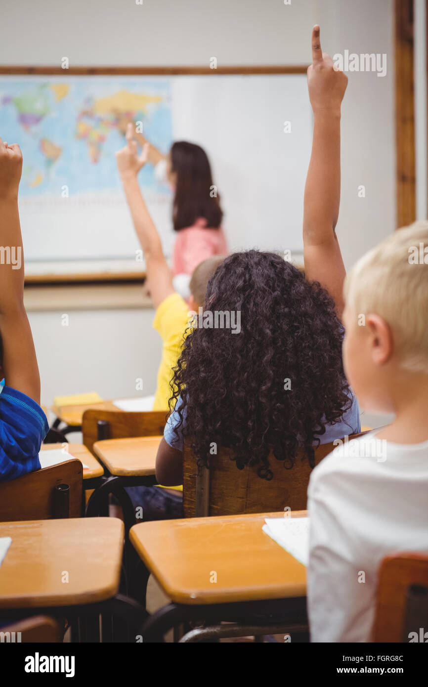 Students raising hands to answer a question Stock Photo - Alamy