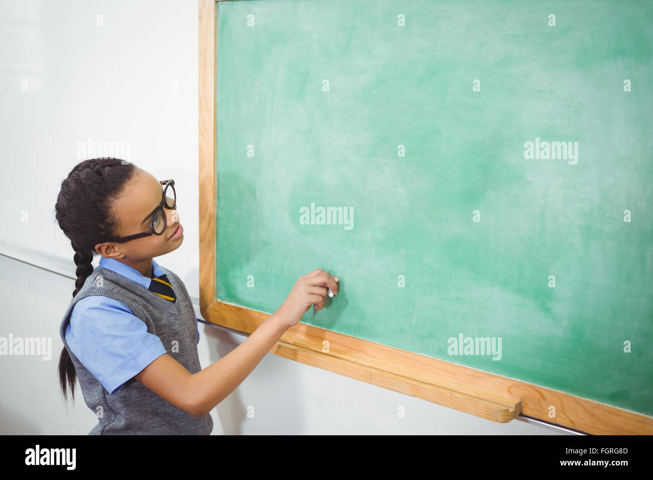 Student writing on the blackboard in class Stock Photo - Alamy