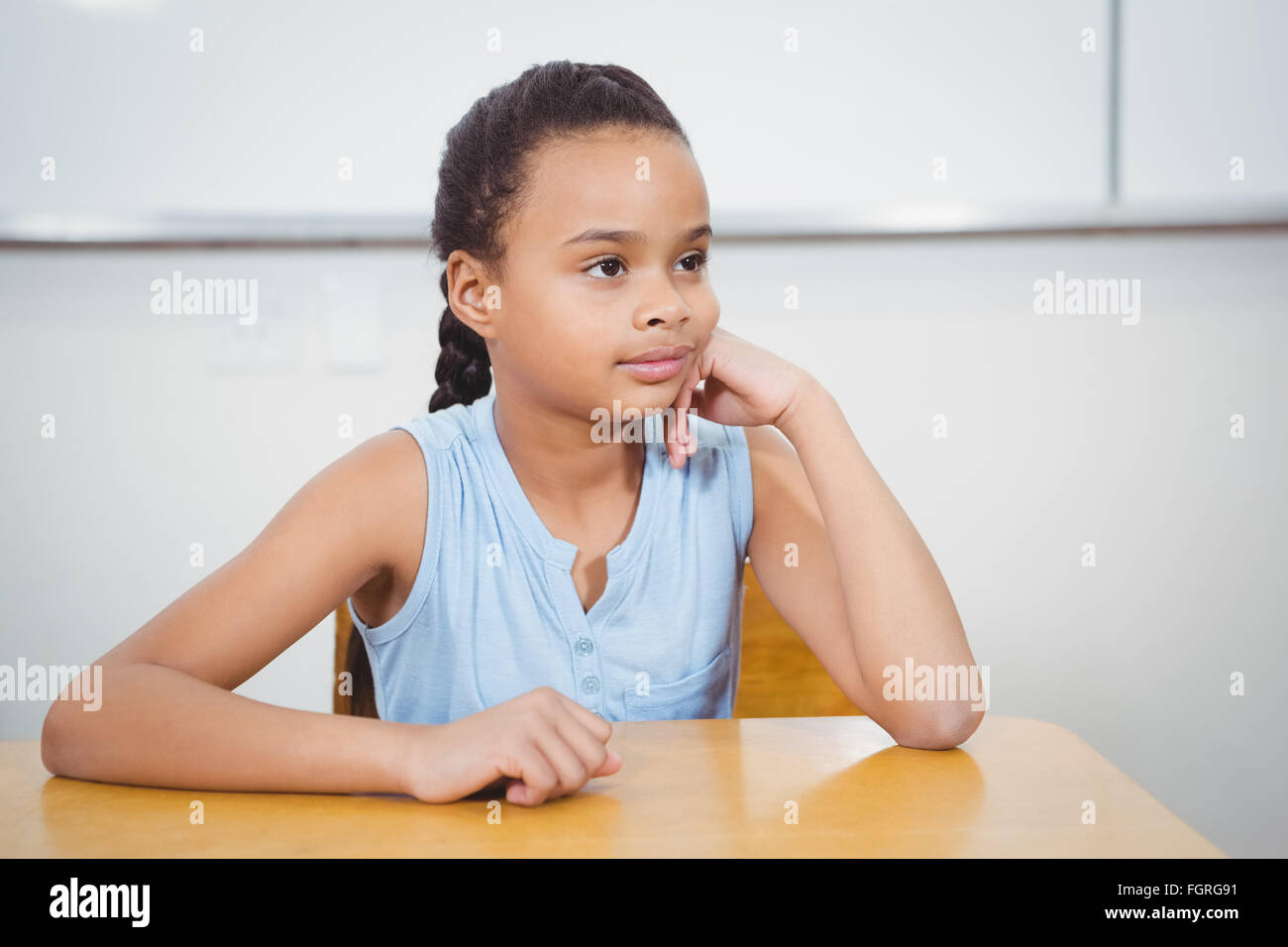 Happy student sitting at a desk Stock Photo - Alamy