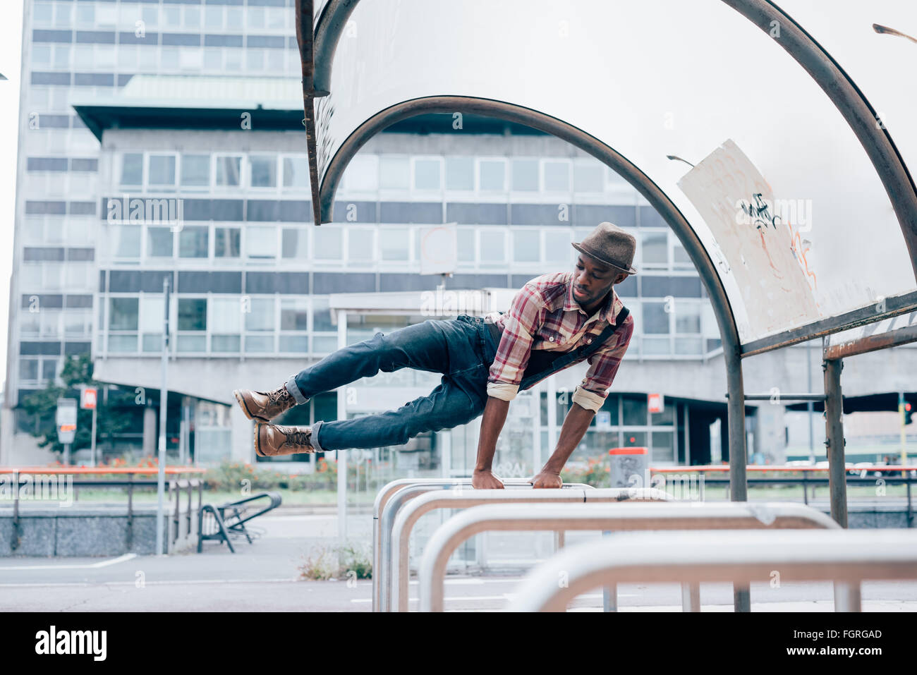 Filtered young handsome afro black man jumping leaning his hand on a ...