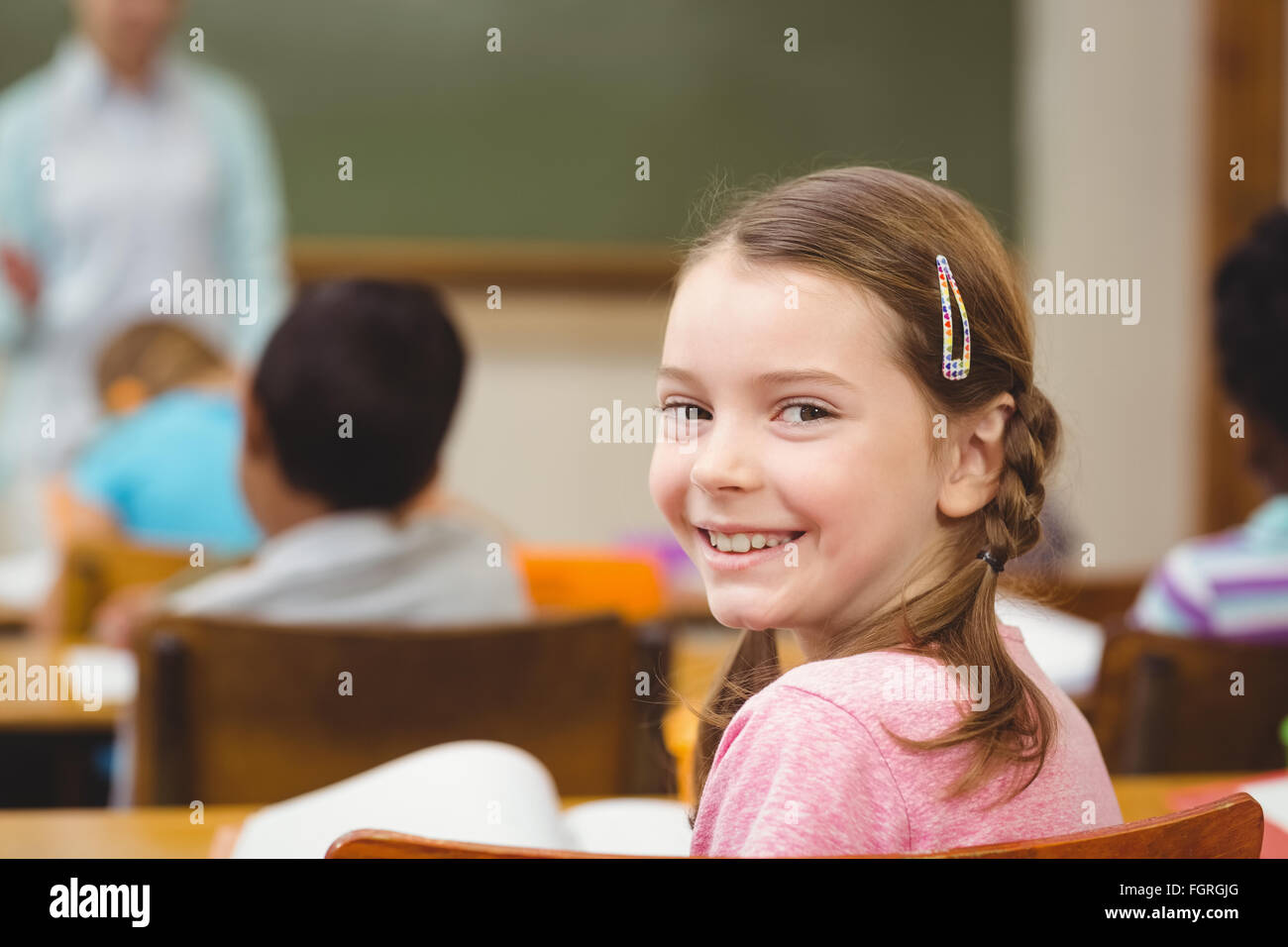 Pupil smiling at camera during class Stock Photo - Alamy