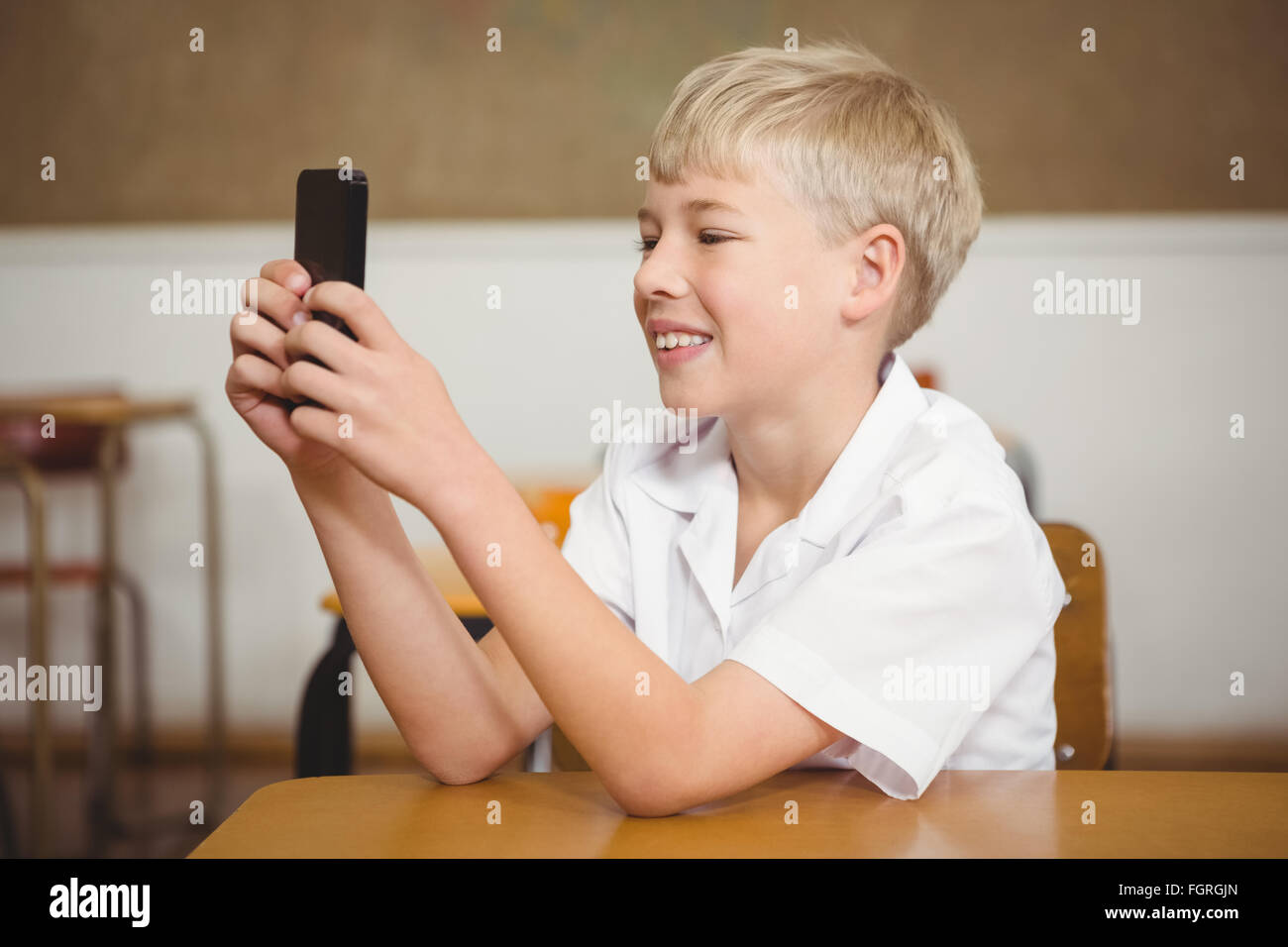 Student using a mobile phone in class Stock Photo - Alamy
