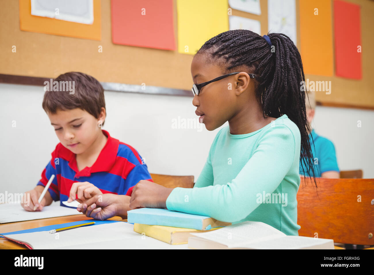 Student helping fellow student in class Stock Photo - Alamy