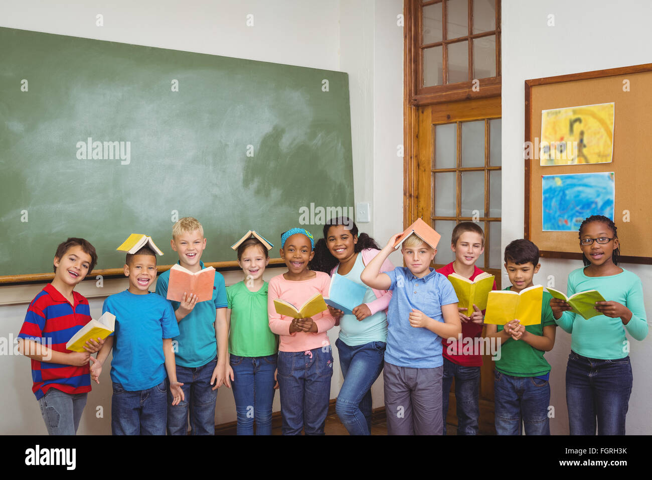 Cheerful boy standing books hi-res stock photography and images - Alamy