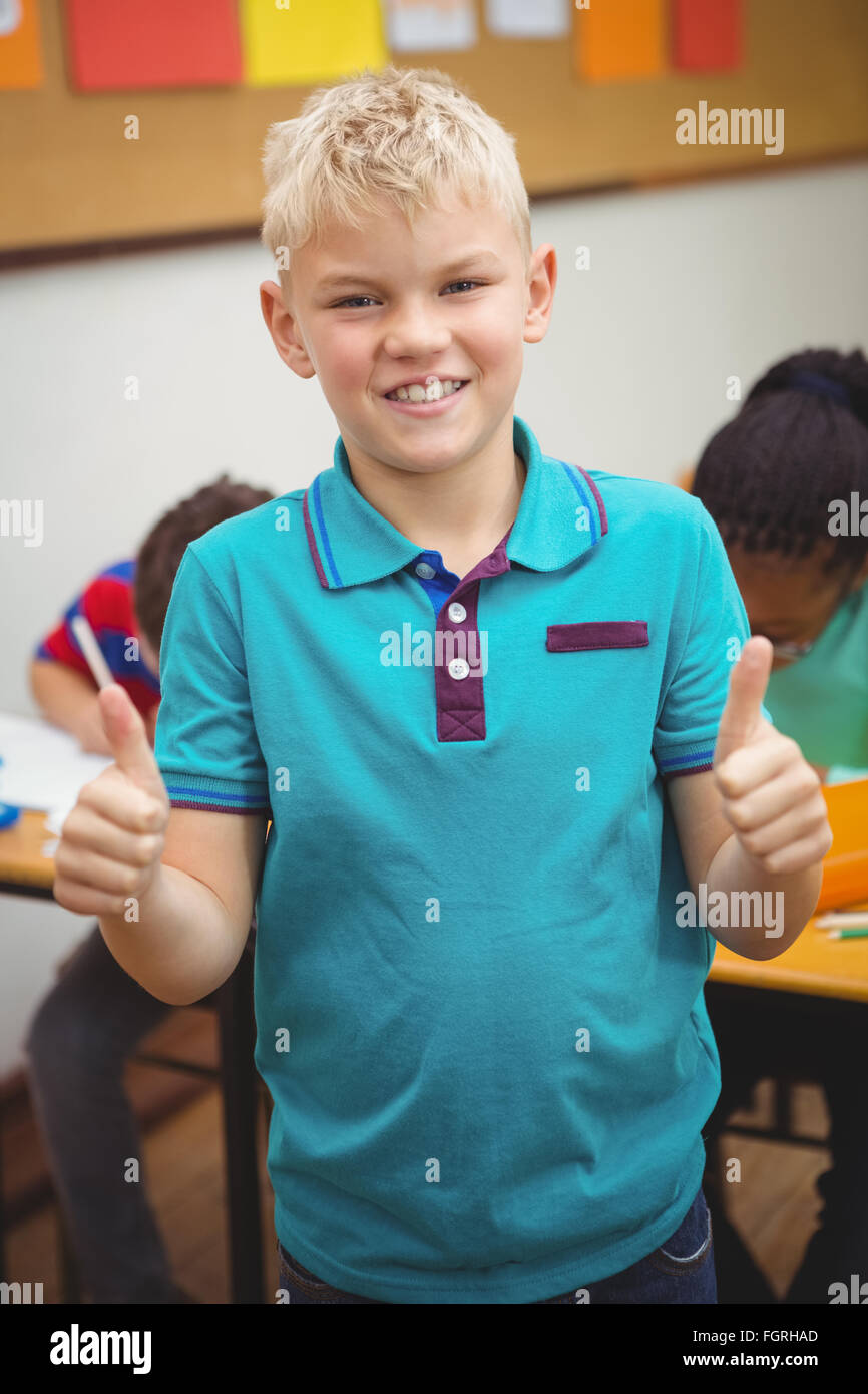 Smiling student with thumbs up Stock Photo - Alamy