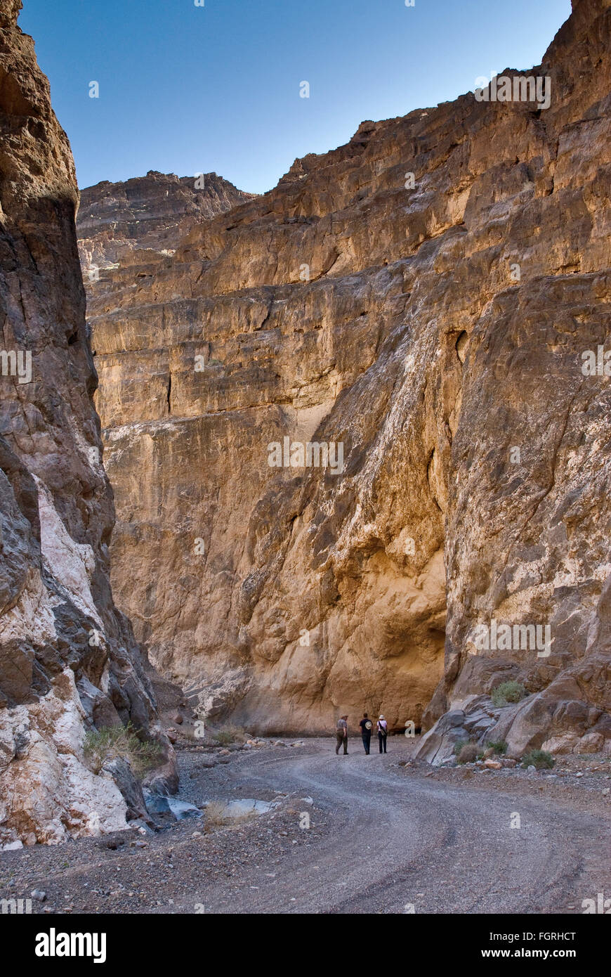 Tourists hiking the narrows of Titus Canyon in Grapevine Mountains ...