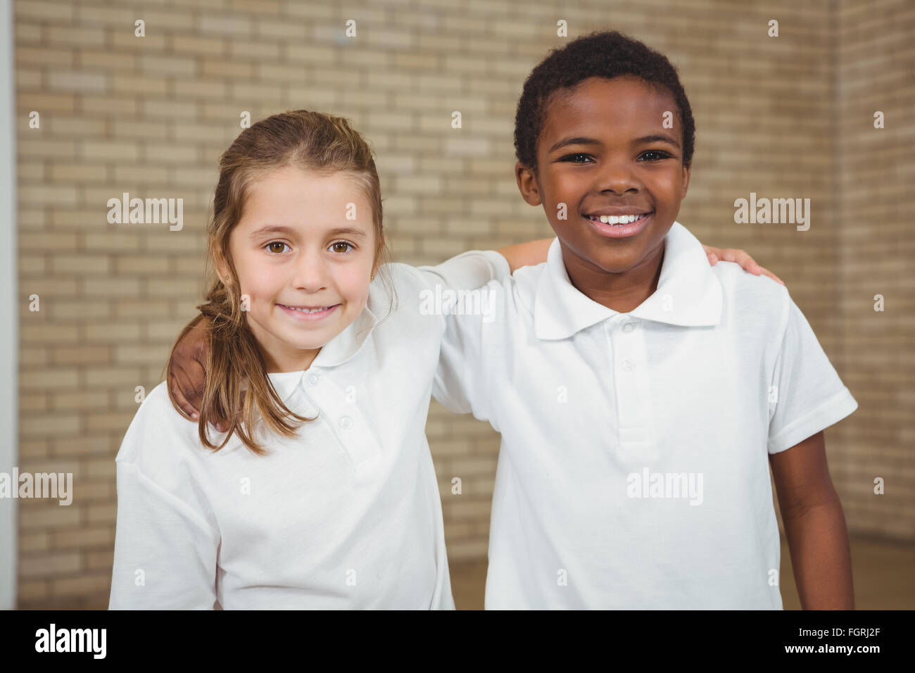 Pupils smiling with arms around each other Stock Photo - Alamy