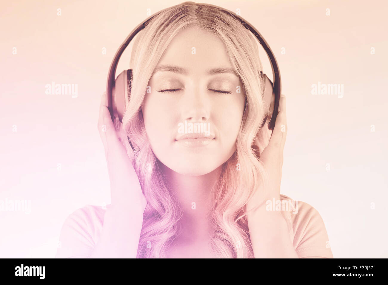 Smiling blonde woman listening music hi-res stock photography and images - Alamy
