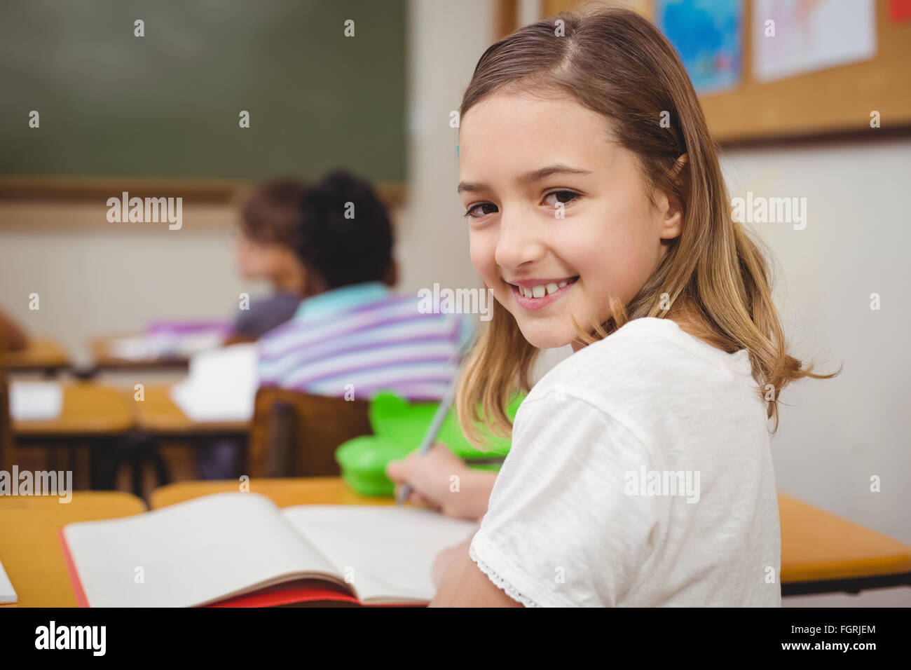 Pupil smiling at camera during class Stock Photo - Alamy